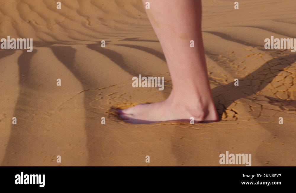 Female legs go on sand in desert. Girls feet step Stock Video Footage ...