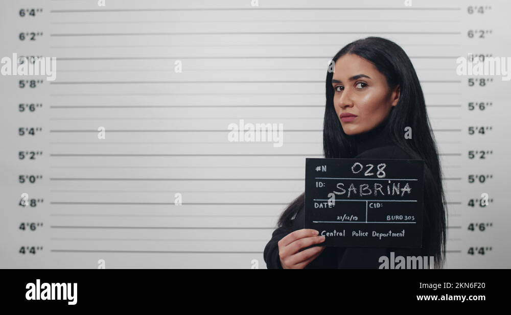 Side profile mugshot of female mixed race person with long hair turning ...