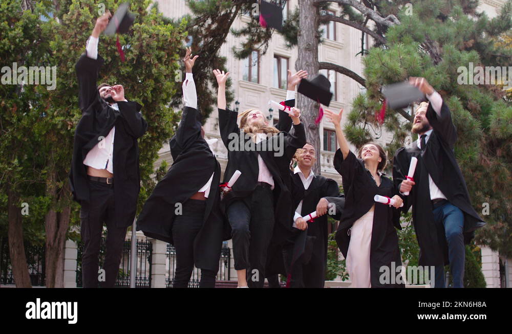 Excited multiracial students graduates happy throw up the graduation ...