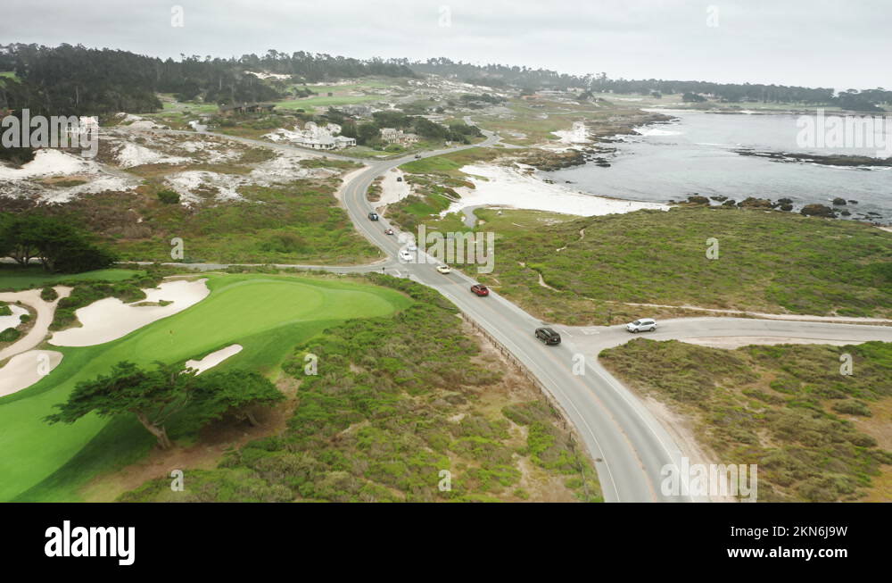 Cinematic aerial 4K view of 60s and 70s vintage cars rally along scenic ...