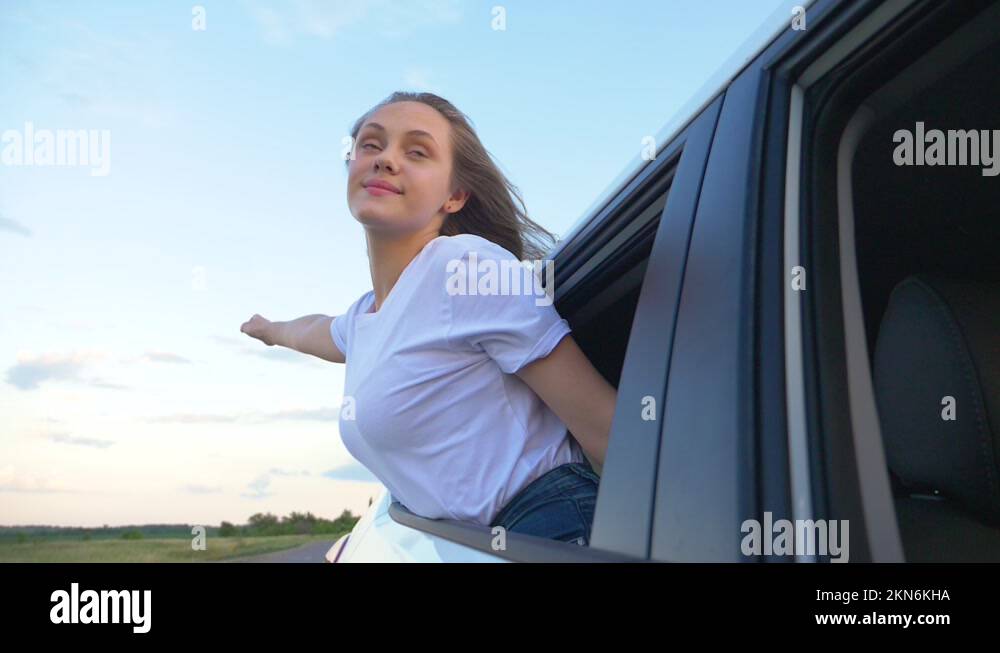 A happy family travels by car. A teenage girl climbed out of a car ...