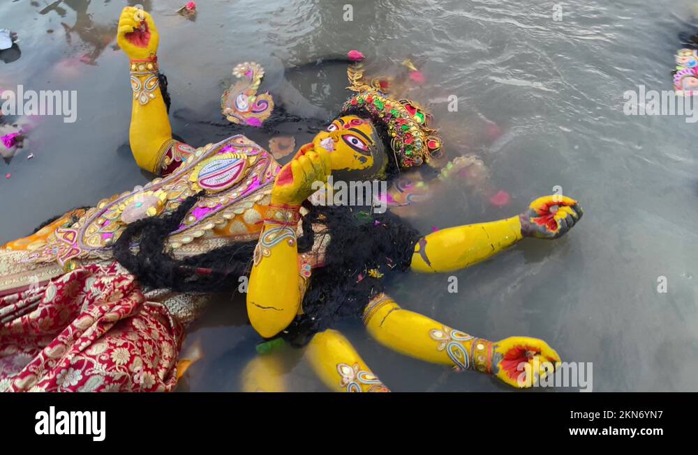 Submersion of Indian goddess Durga in river.Idol of Goddess Durga is ...