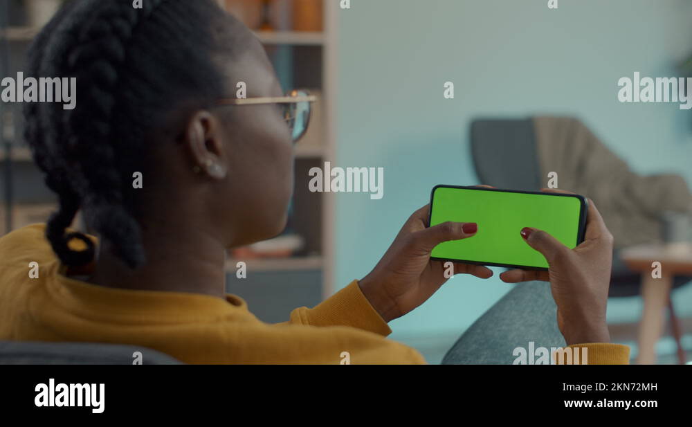 African american woman texting on green screen of smartphone Stock Video Footage - Alamy