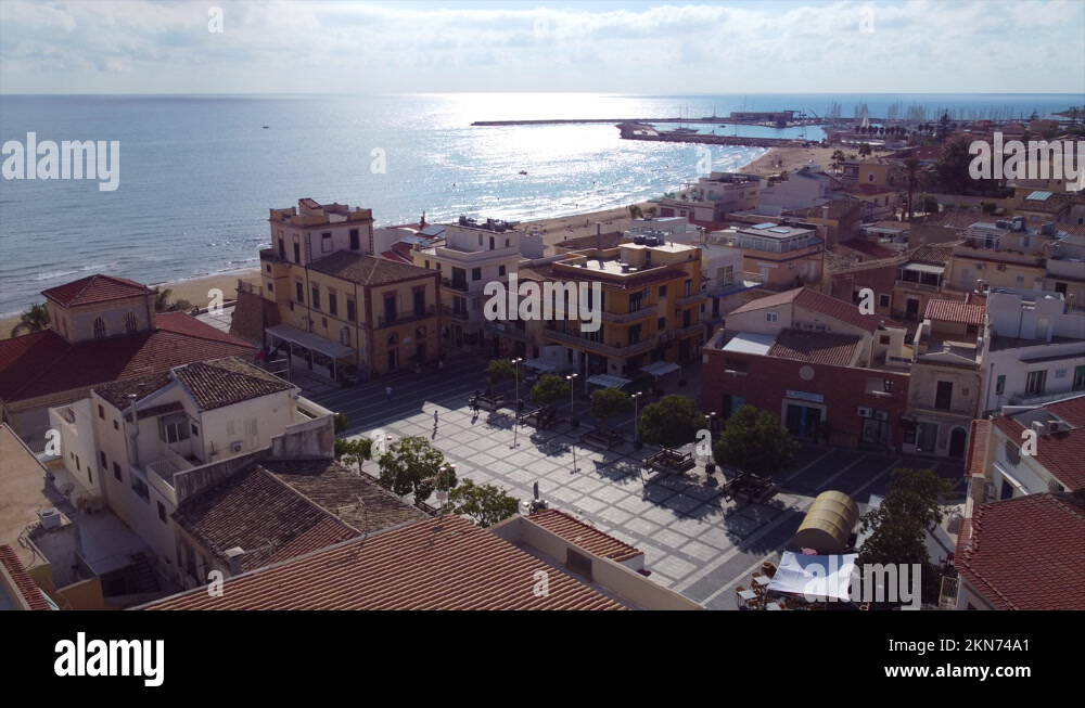 flying counter clockwise around piazza of beautiful Marina di Ragusa in ...