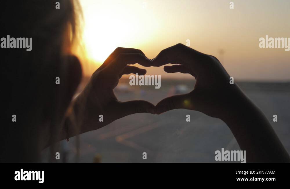 Girl doing heart hands, child hands forming a heart shape with sunset ...