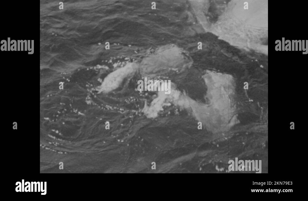 1940s: Legs kicking in water. People using floatation devices, swimming ...