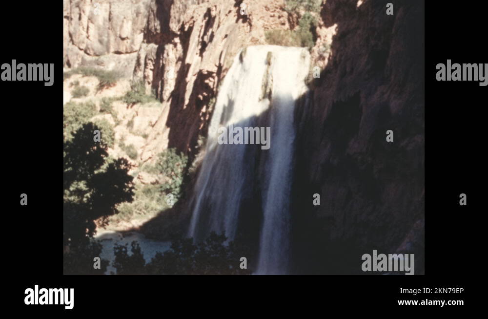 1940s:Waterfall cascading over rocky cliff into plunge pool. Trees ...