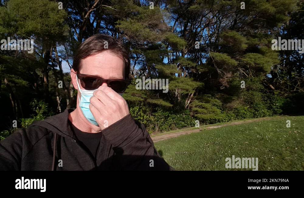 Older man puts his mask on while out side vlogging Stock Video Footage ...