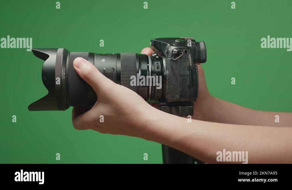 Hand Adjusting Zoom And Focus On Digital Camera Lens On Green Screen ...