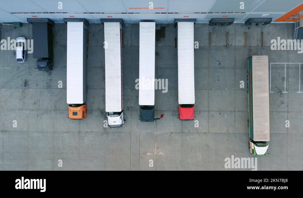 Semi-trailers trucks stand at warehouse ramps for loading and unloading ...