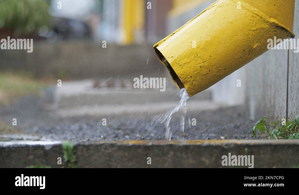 Rainwater flows out of building drain pipe Stock Video Footage - Alamy