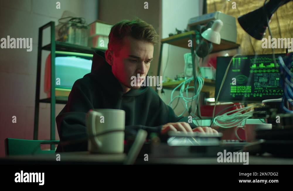 Hacker Typing On Keyboard At Night Breaking Password Using Laptop And