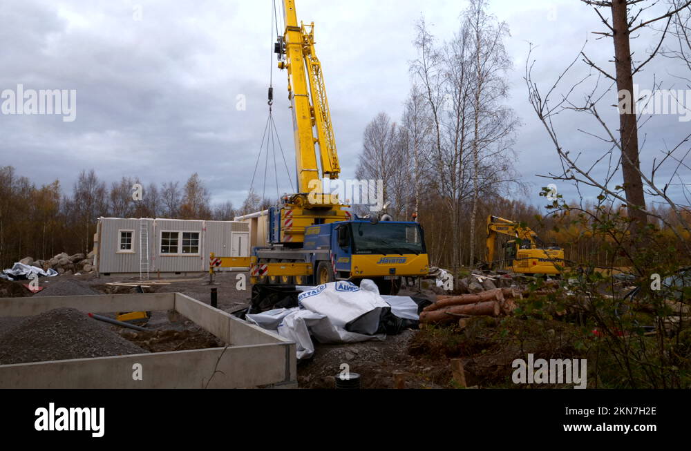 Crane machine lifting panels for construction of new prefabricated ...