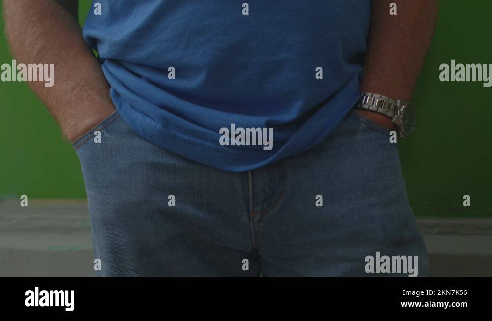 hand in pockets of a man's pants on the corner house. Waiting for a ...