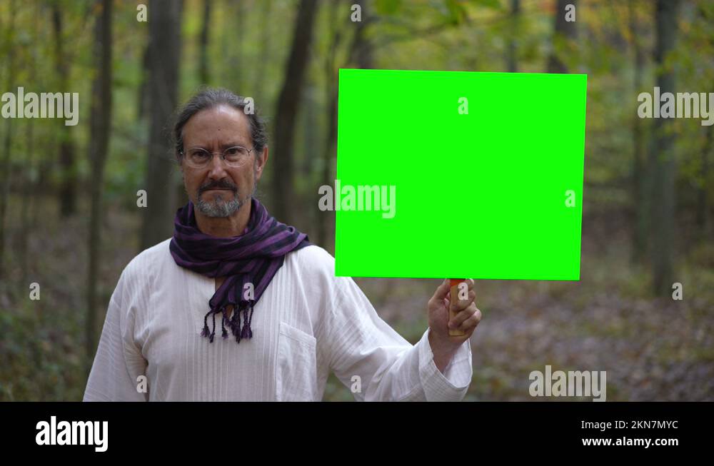 Hipster, smiling mature man holding blank green screen chroma key sign ...