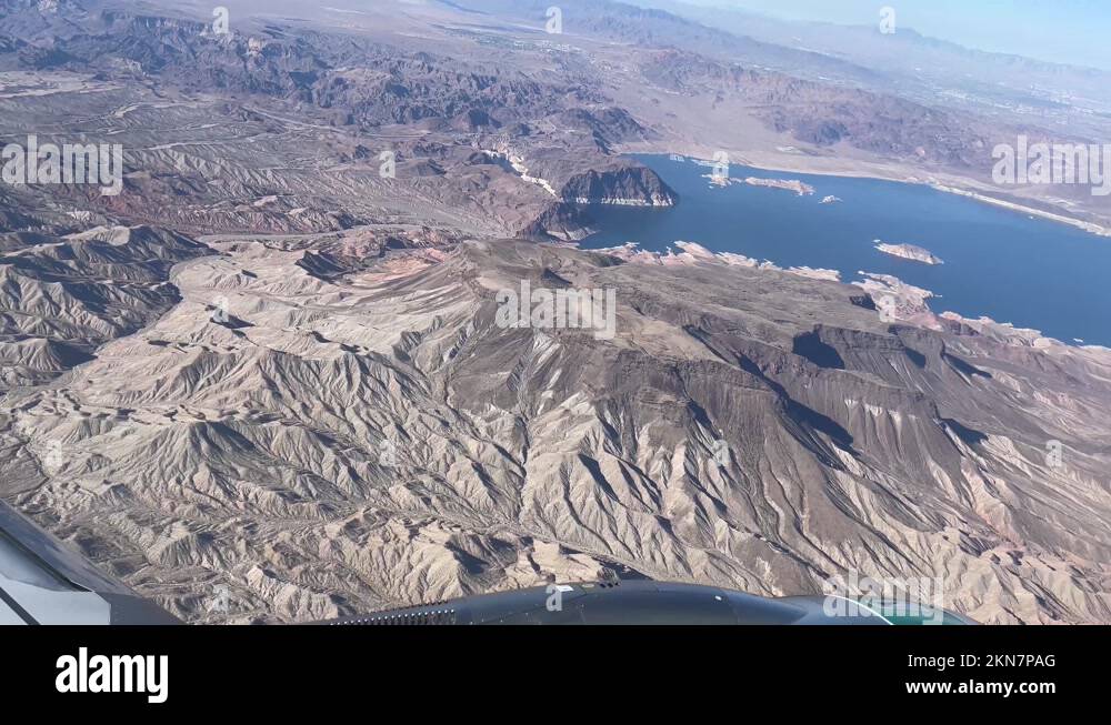Looking out the window of an airplane as it flys over the Hoover Dam ...