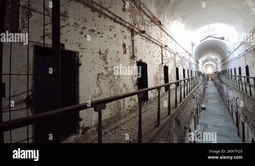 Pan from left side of corridor to view down center of cellblock at ...