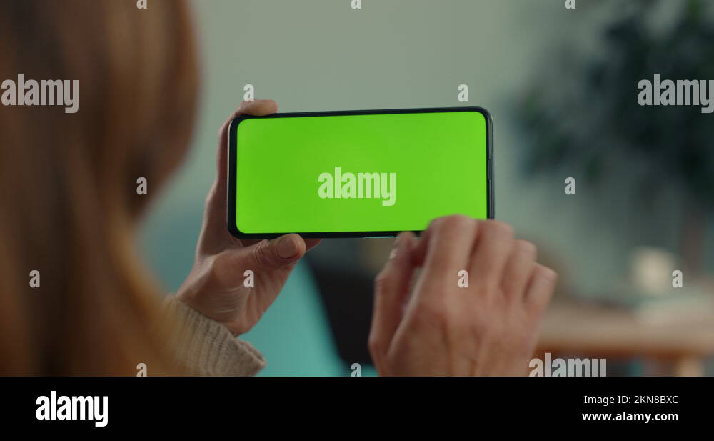 Woman scrolling with finger on green screen of mobile Stock Video ...