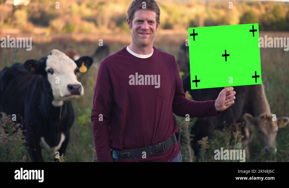 Smiling farmer man holding green screen chroma key sign surrounded by ...