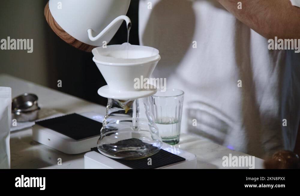 The process of brewing specialty coffee. Brewing coffee in a funnel ...