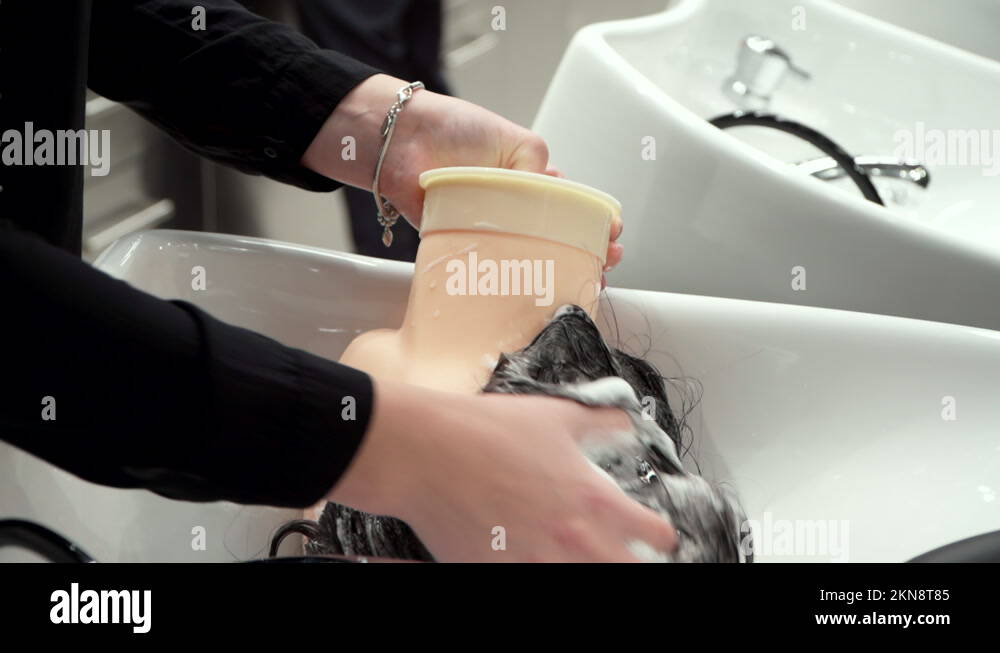 students wash the hair of mannequins at a hairdressing course Stock ...