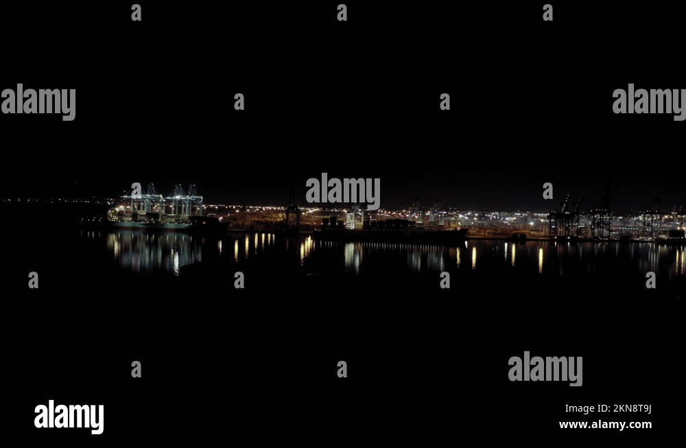 Wide footage of cargo ship with cargo containers stands on a berth in ...