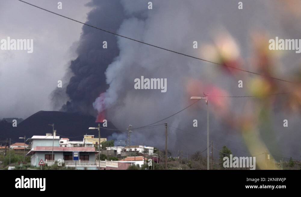 A huge cloud of volcanic ash and gas engulfs the sky above the village ...