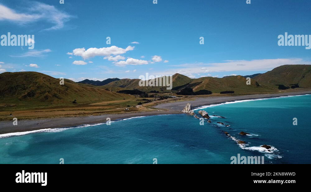 Perfect Summer day aerial across New Zealand's White Rock Pacific coast ...