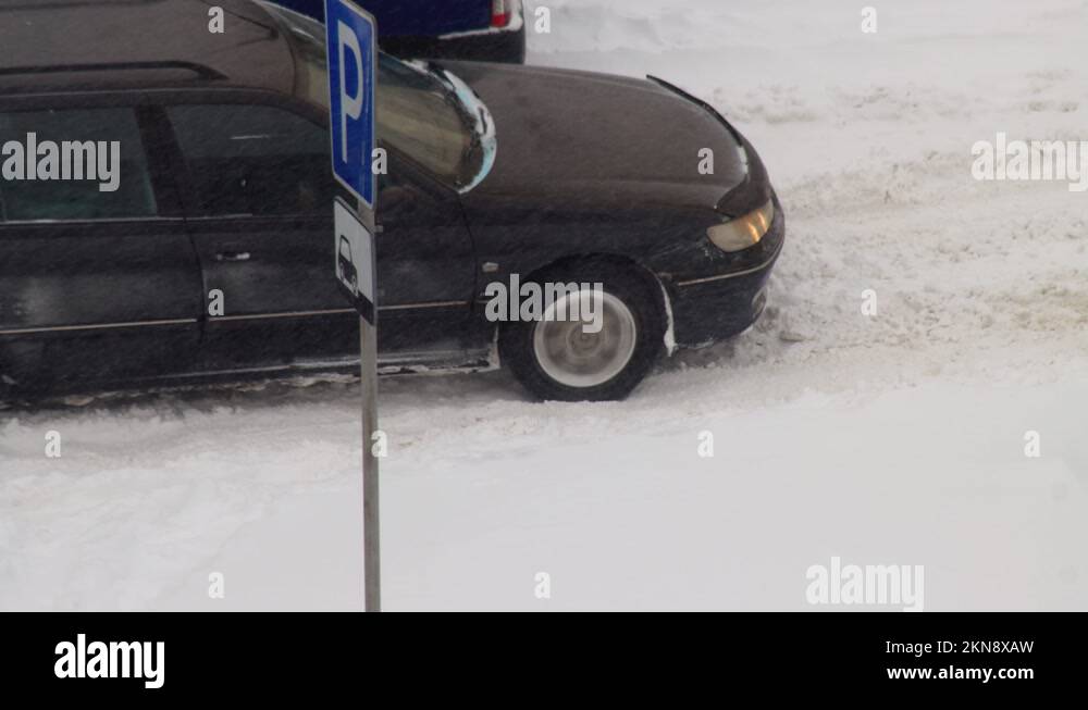 A passenger car slips in the snow in winter and tries to leave. Wheel ...