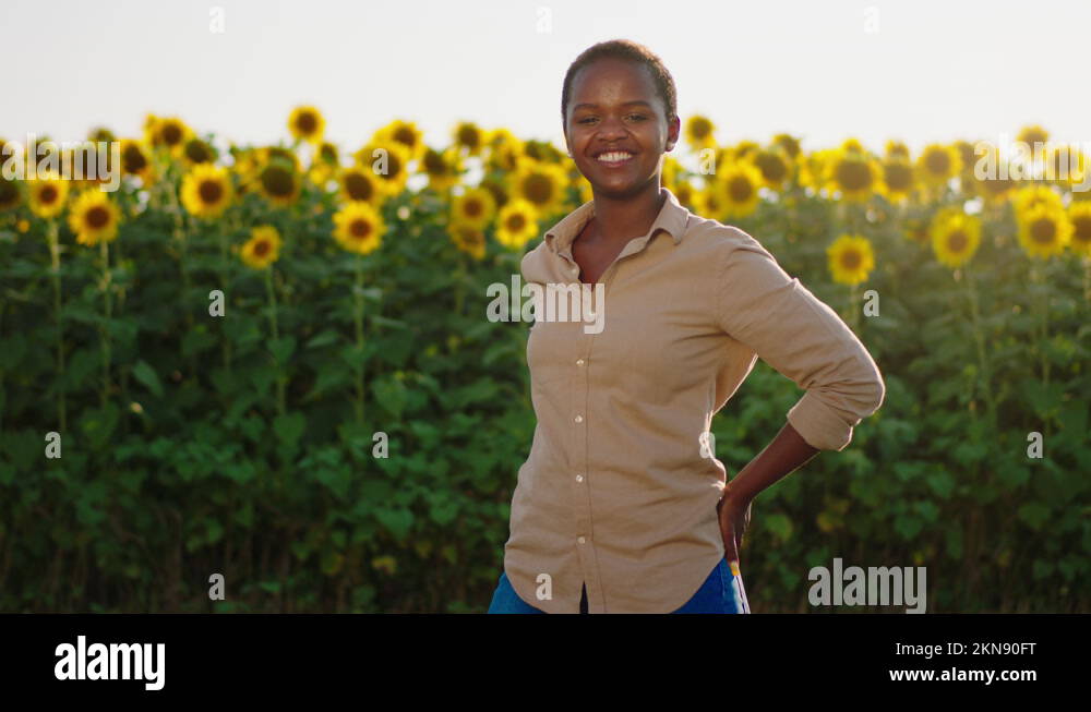 A stunning black woman with short blonde hair is wearing a tan shirt ...