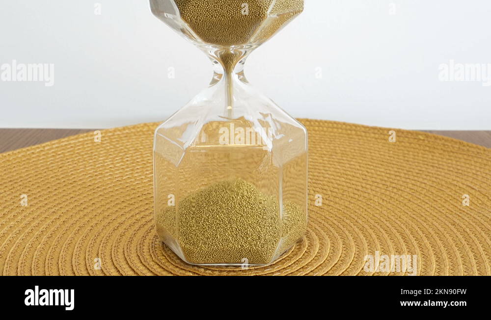 Golden sand is poured into a hourglass in time laps Stock Video Footage ...
