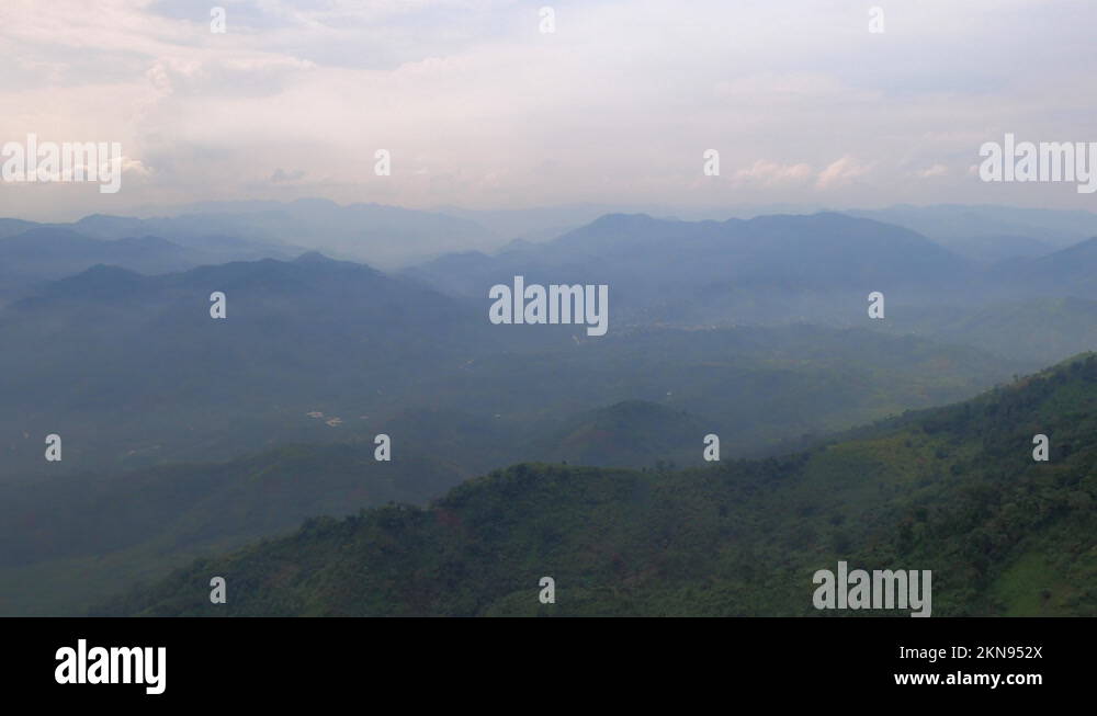 Aerial flight: foggy jungle town in distant mountain valley, DRC Congo ...