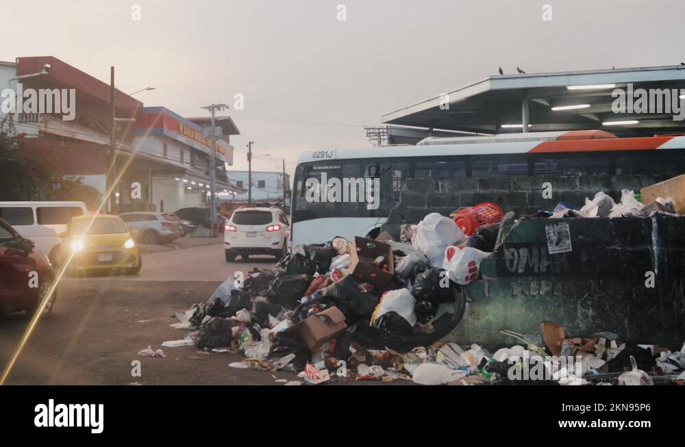 Trash, garbage, recycle trash in a crowded container in a busy street ...