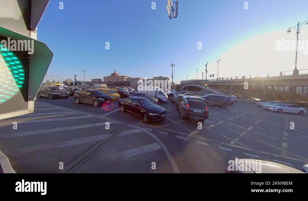 Traffic at a busy intersection captured by a 360-degree camera, time ...