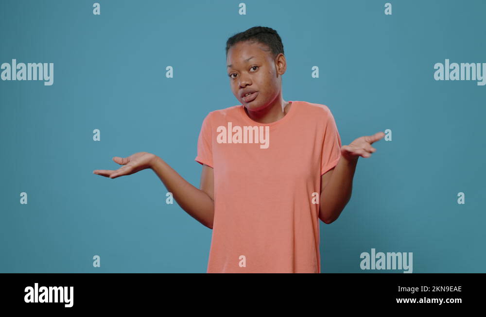 Confused adult raising hands and shoulders in studio Stock Video ...