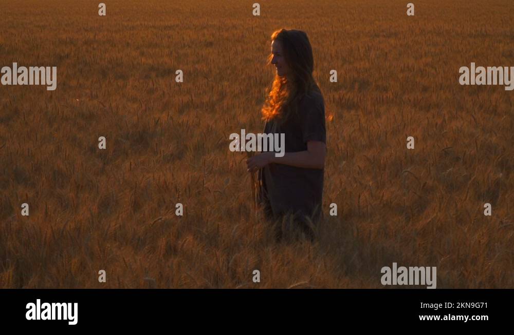 A woman runs across the field at sunset. free spirit of a beautiful ...