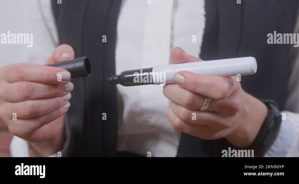 School teacher in white blouse with neat manicure stands IN classroom ...