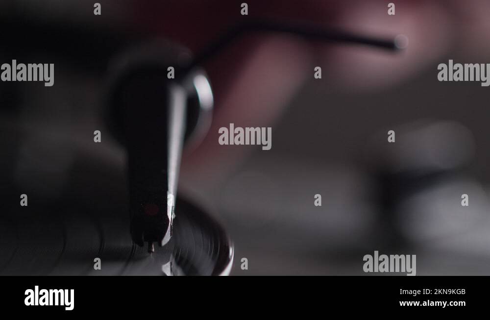 Male hand put needle on record spinning on turntable. Listening the ...