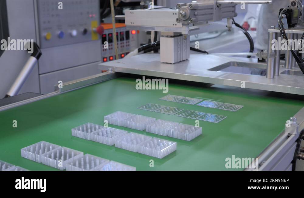 Pick and place robotic arm manipulator moving plastic detail on ...