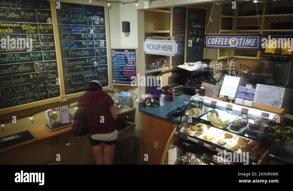 Blur of people rushing around ordering from a barista at a coffee ...