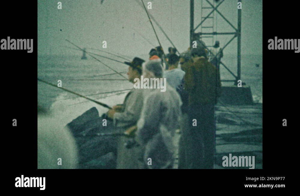 1970s: Waves crash on jetty. Men fish Stock Video Footage - Alamy