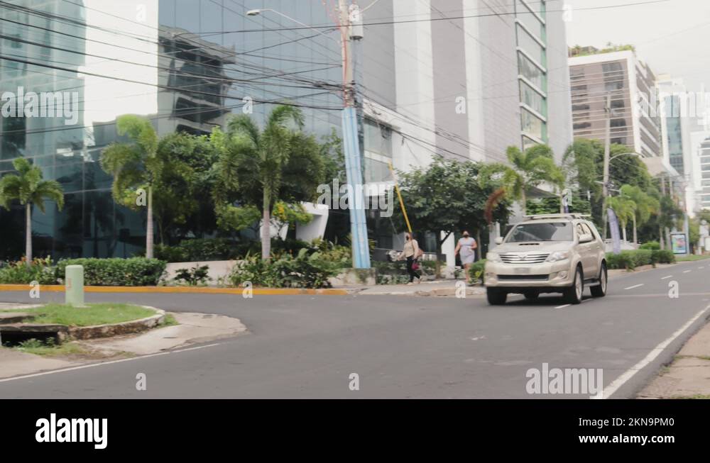 Pan view from right to left of city crossroads with traffic lights ...