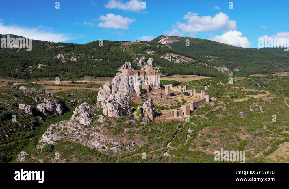 medieval castle between rocks on a great mountain. walled city in ...