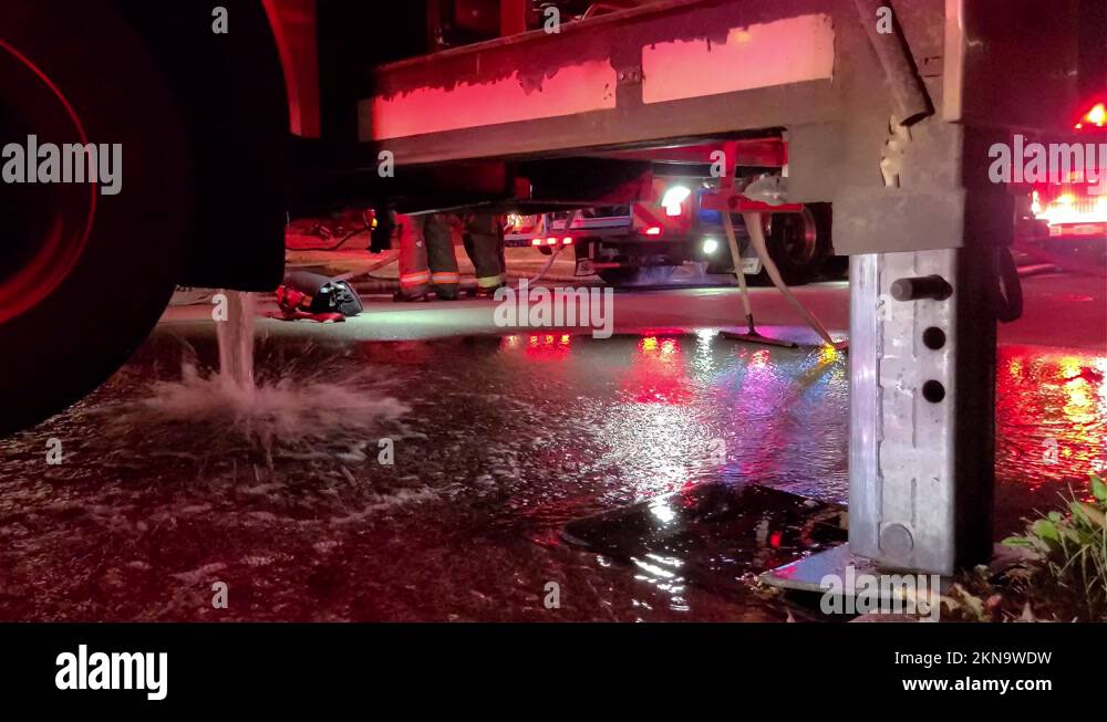 Water flowing from a parked Fire Truck in Toronto Canada surrounded by ...