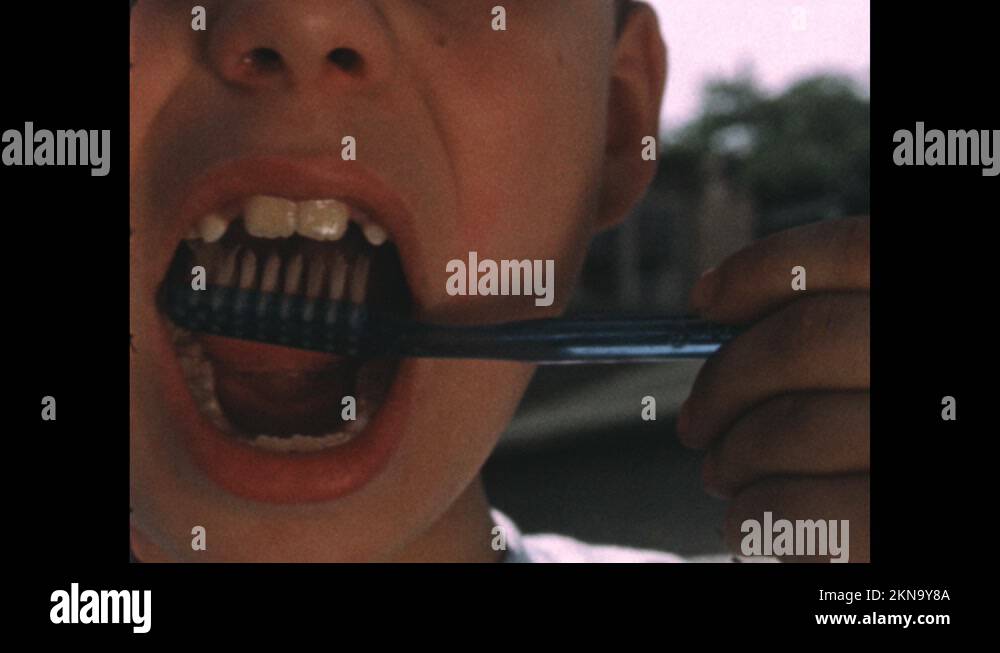 1950s: Close up of boy's mouth, boy brushing teeth. Boy brushing teeth ...
