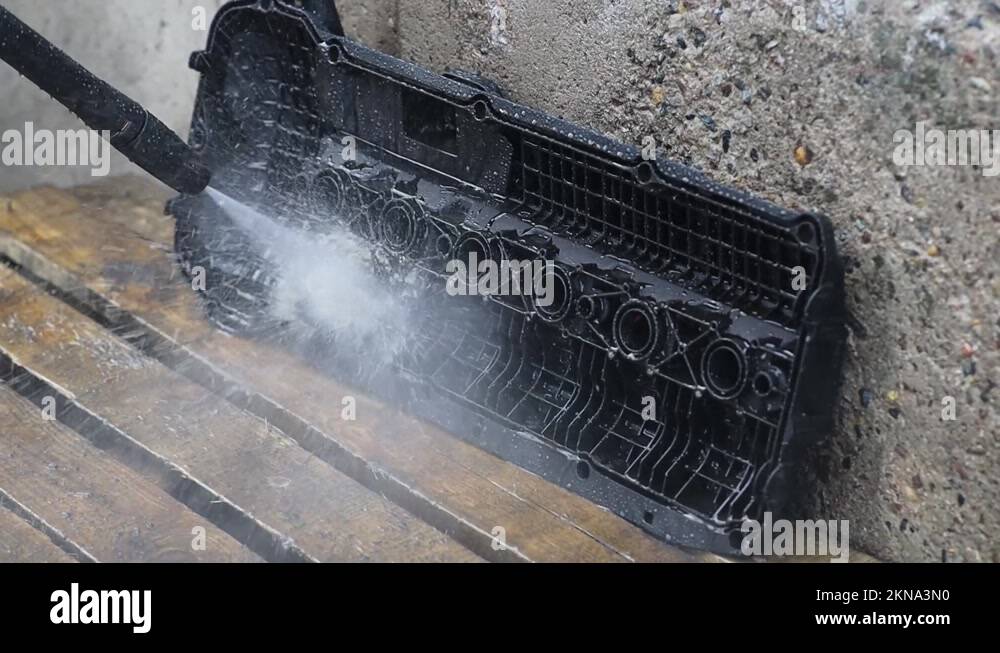 washing with a jet of a high pressure of the valve cover of the car ...