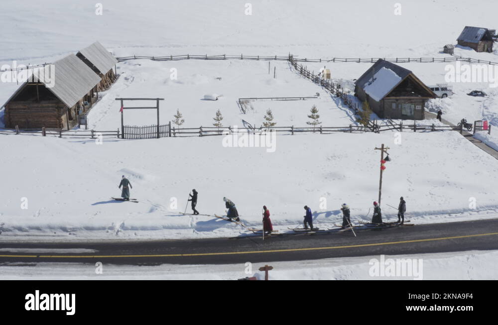 Tuva men dressed in traditional clothing walking in fur ski in snow ...