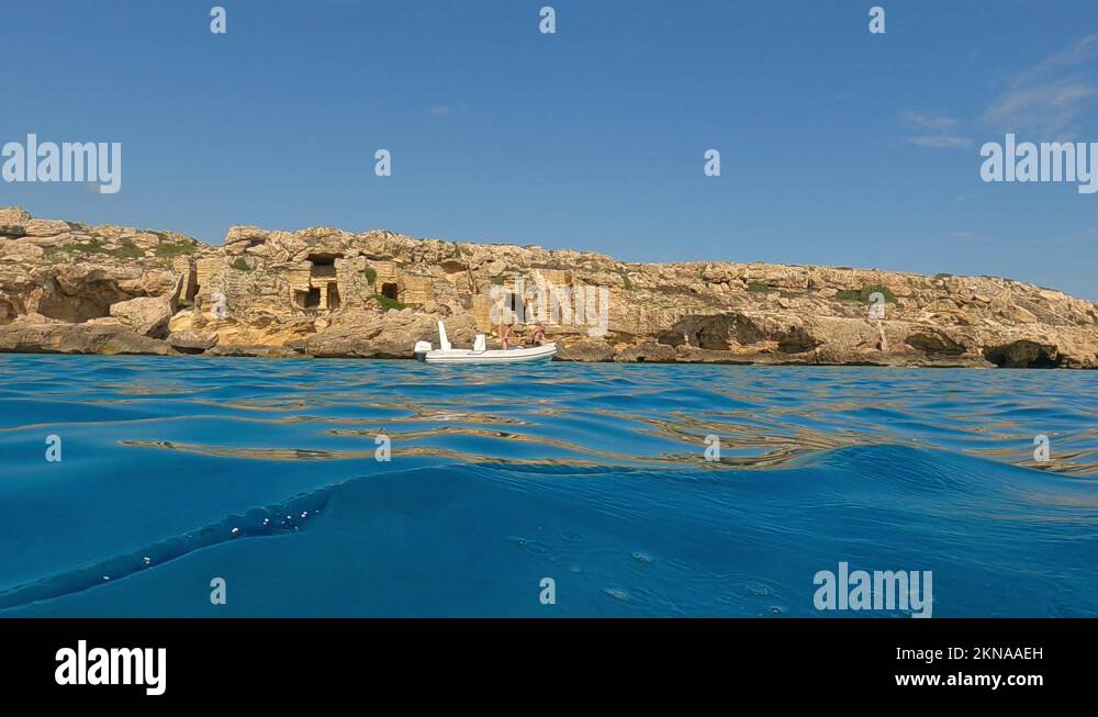 Extreme low-angle sea-level view from sailing yacht of touristic dinghy ...