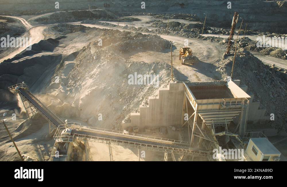 Arial view of the open pit mine. Front end loader loading sand into ...