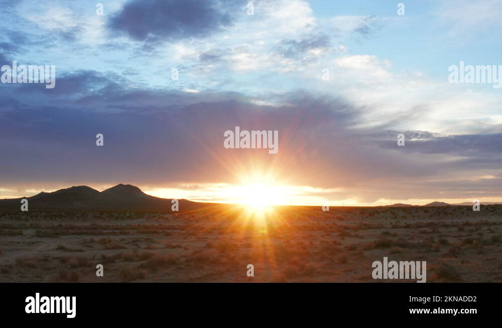 The sun flares over the horizon as dawn comes to the Mojave Desert's ...